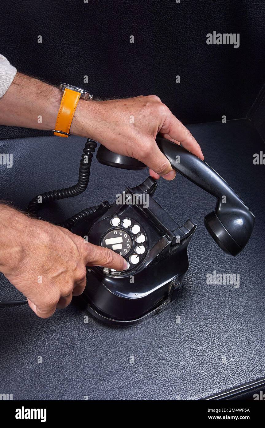 Male hands dial a phone number on a vintage rotary telephone Stock ...
