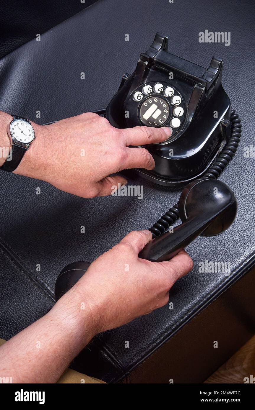 Male hands dial a phone number on a vintage rotary telephone Stock ...