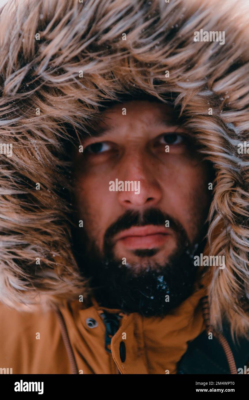 Headshot photo of a man in a cold snowy area wearing a thick brown ...