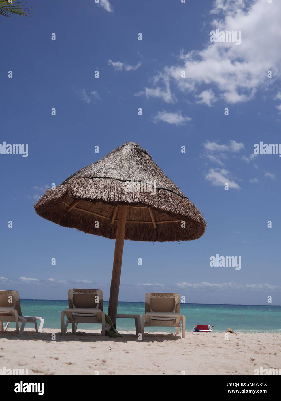 caribbean straw parasol Stock Photo - Alamy