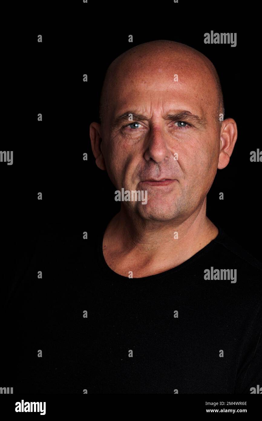 A vertical portrait of a bald man over 50 years looking at the camera ... A vertical portrait of a bald man over 50 years looking at the camera ...