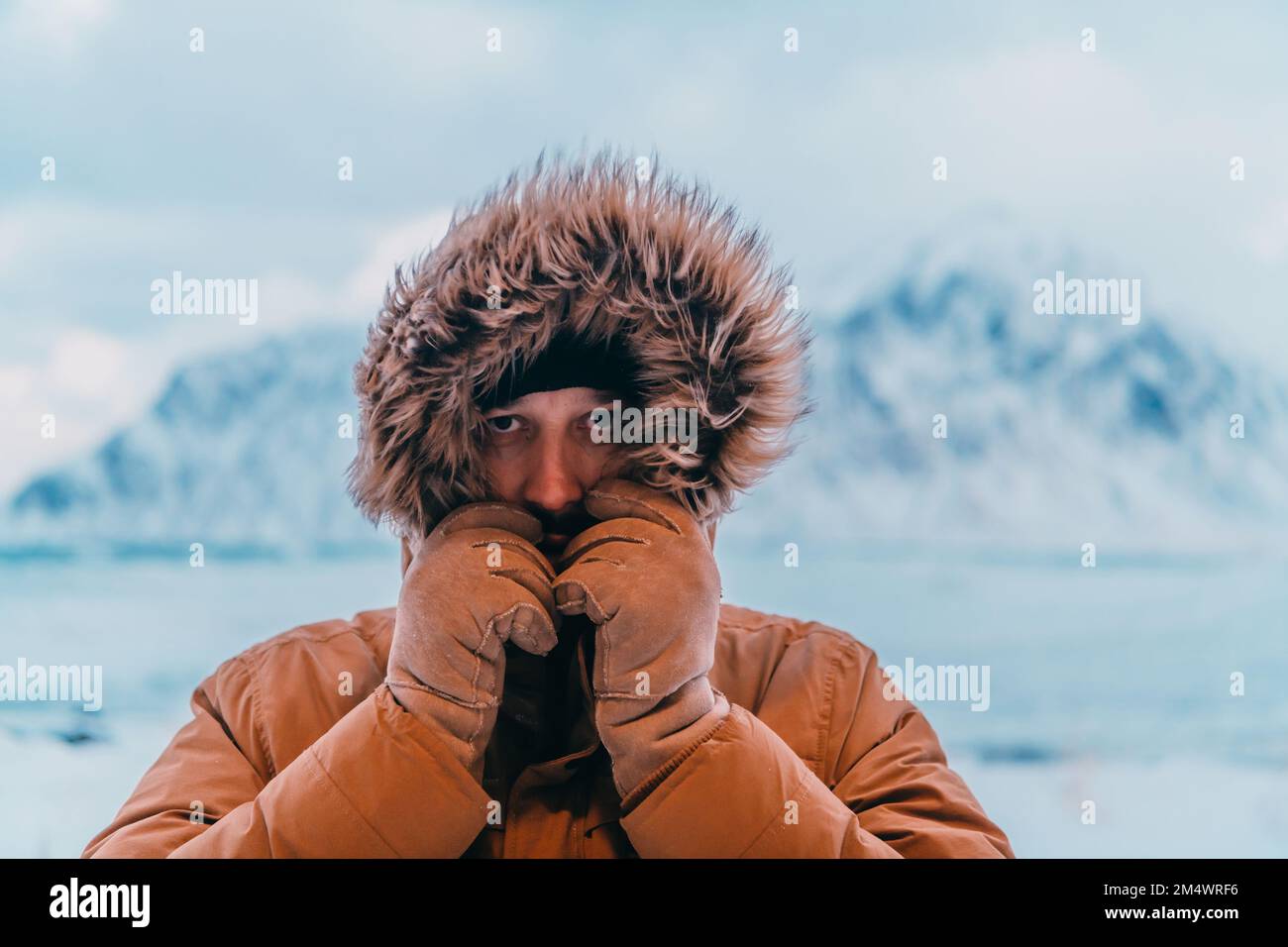 Headshot photo of a man in a cold snowy area wearing a thick brown ...