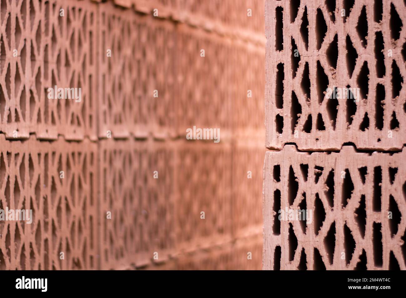 Holey red brick texturte close up Stock Photo - Alamy