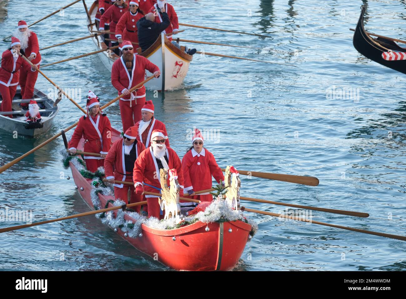 People dressed as Santa Claus row during a Christmas regatta along the ...