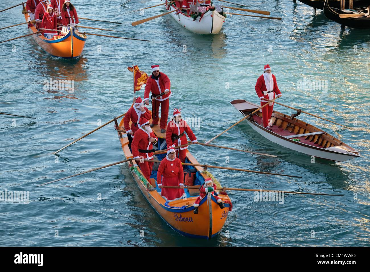 People dressed as Santa Claus row during a Christmas regatta along the ...
