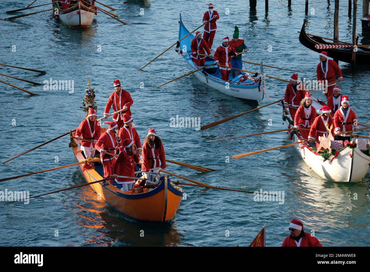 People dressed as Santa Claus row during a Christmas regatta along the ...
