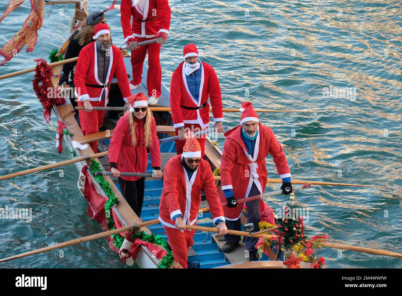 People dressed as Santa Claus row during a Christmas regatta along the ...