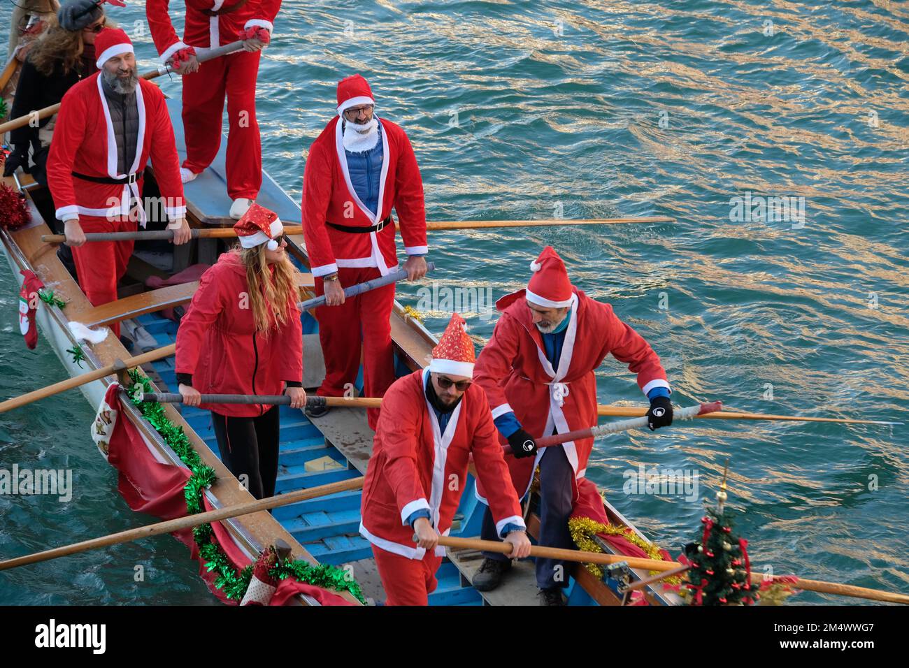 People dressed as Santa Claus row during a Christmas regatta along the ...
