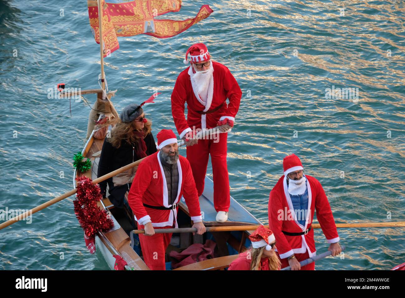 People dressed as Santa Claus row during a Christmas regatta along the ...