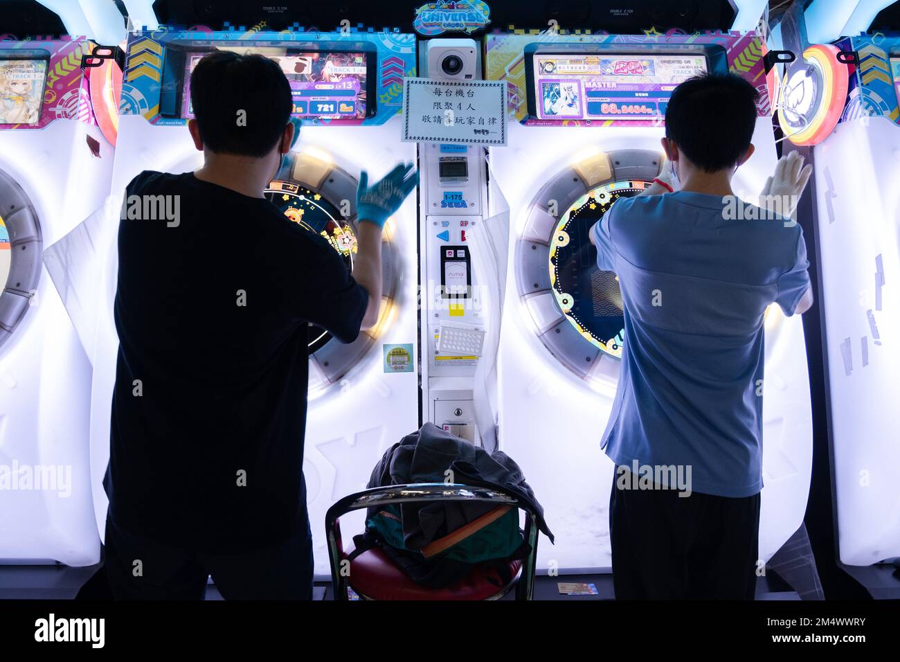 Leung Wang-hoi, right, playing Maimai DX Universe Plus alongside his ...