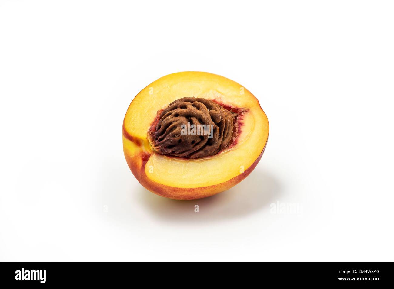 Peach cut in half isolated on white with clipping path included Stock ...