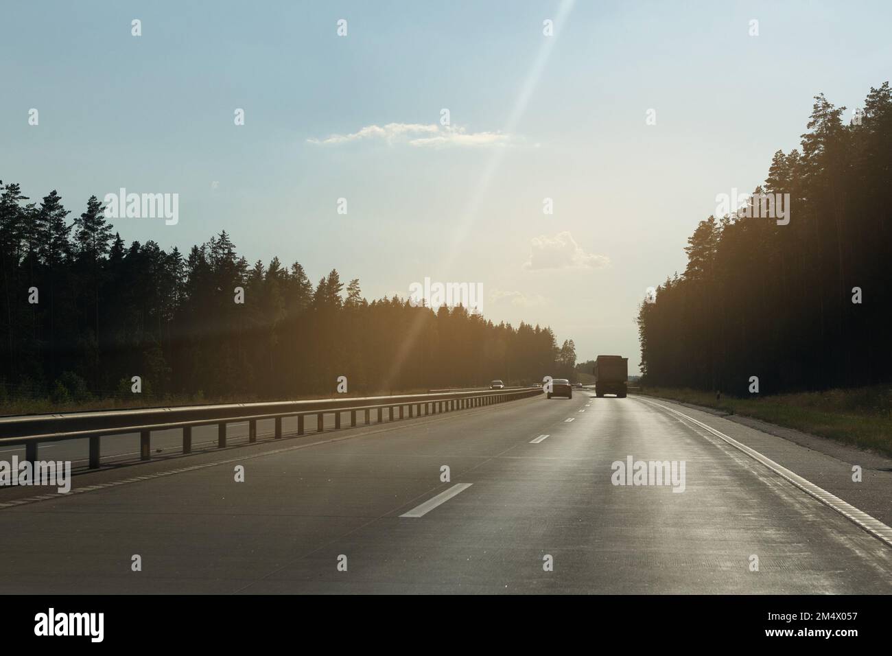 Evening view at sunset. Highway road in the countryside, roadside and ...