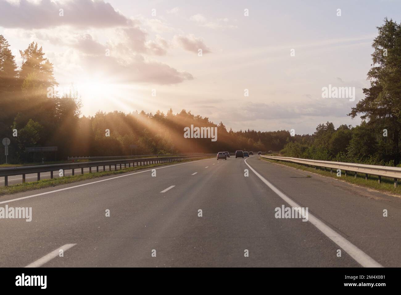 Evening view at sunset. Highway road in the countryside, roadside and ...