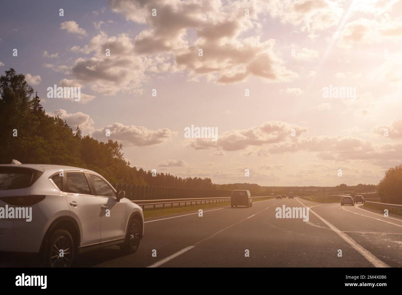 Evening view at sunset. Highway road in the countryside, roadside and ...