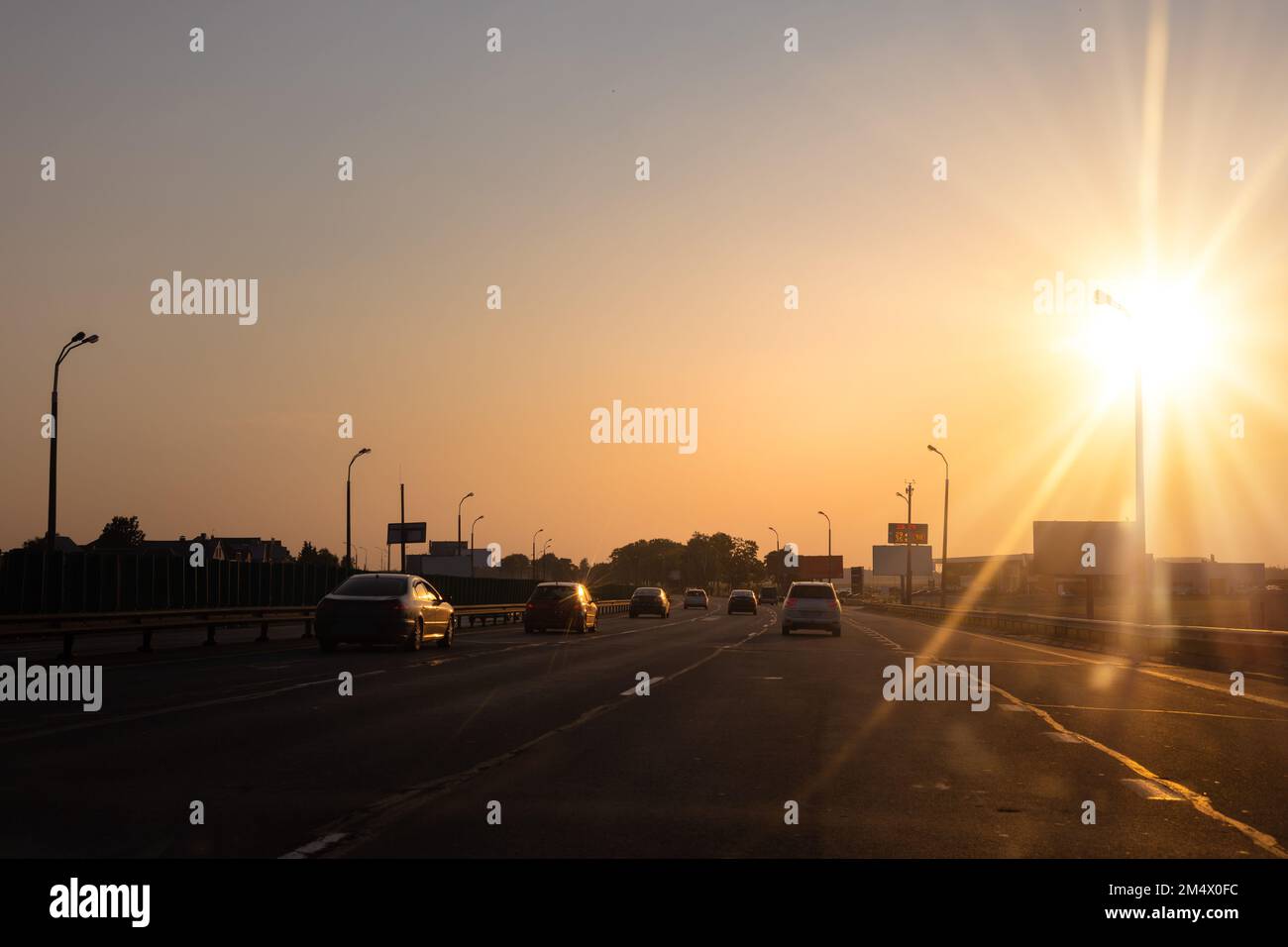 Evening view at sunset. Highway road in the countryside, roadside and ...