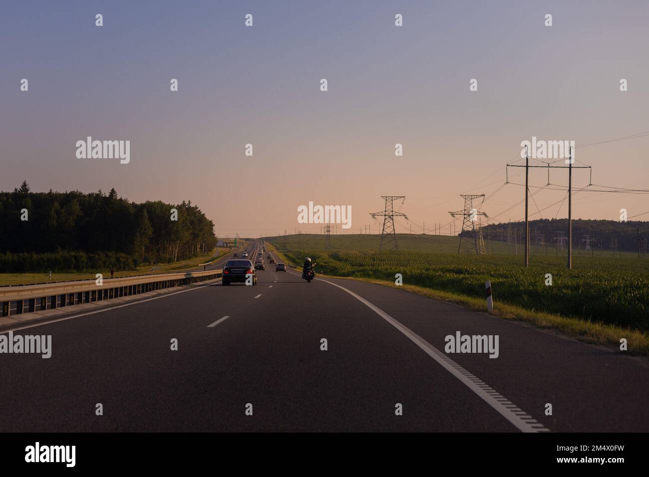 Evening view at sunset. Highway road in the countryside, roadside and ...