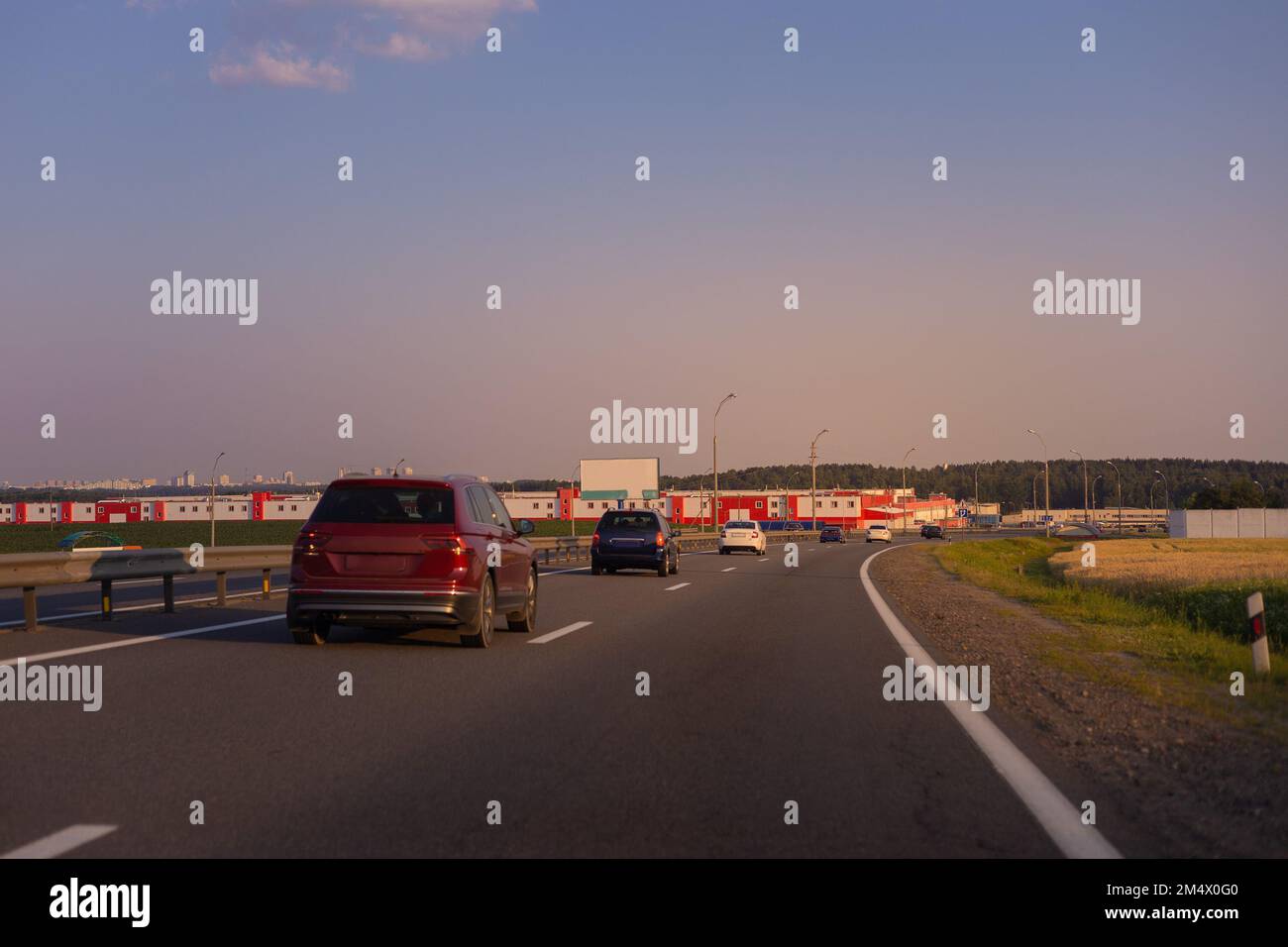Evening view at sunset. Highway road in the countryside, roadside and ...