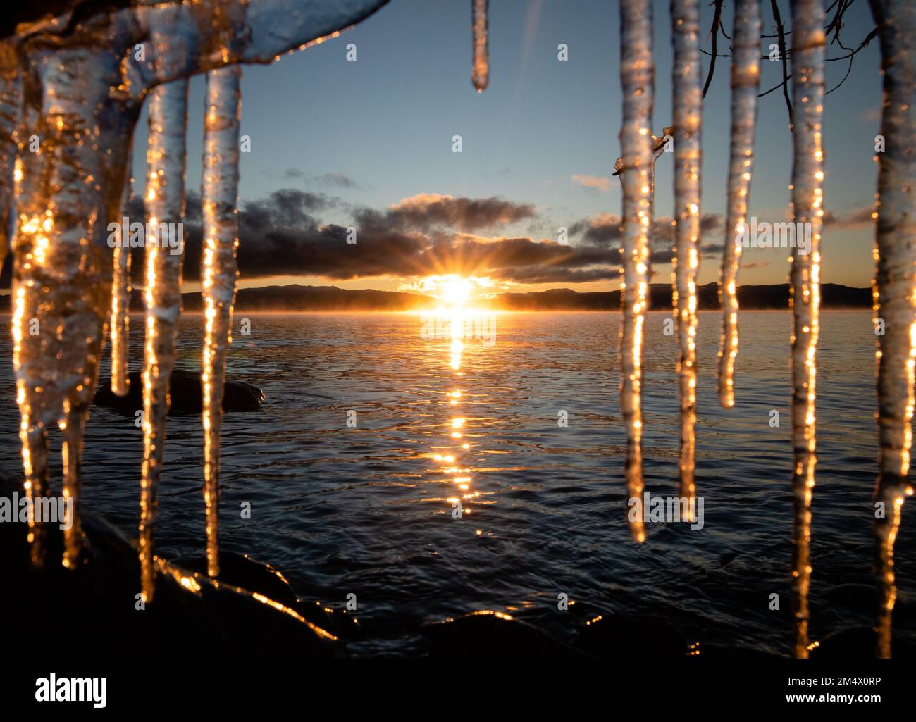 Icy Sunrise on Lake Tahoe - Icicles in front of rising sun landscape ...