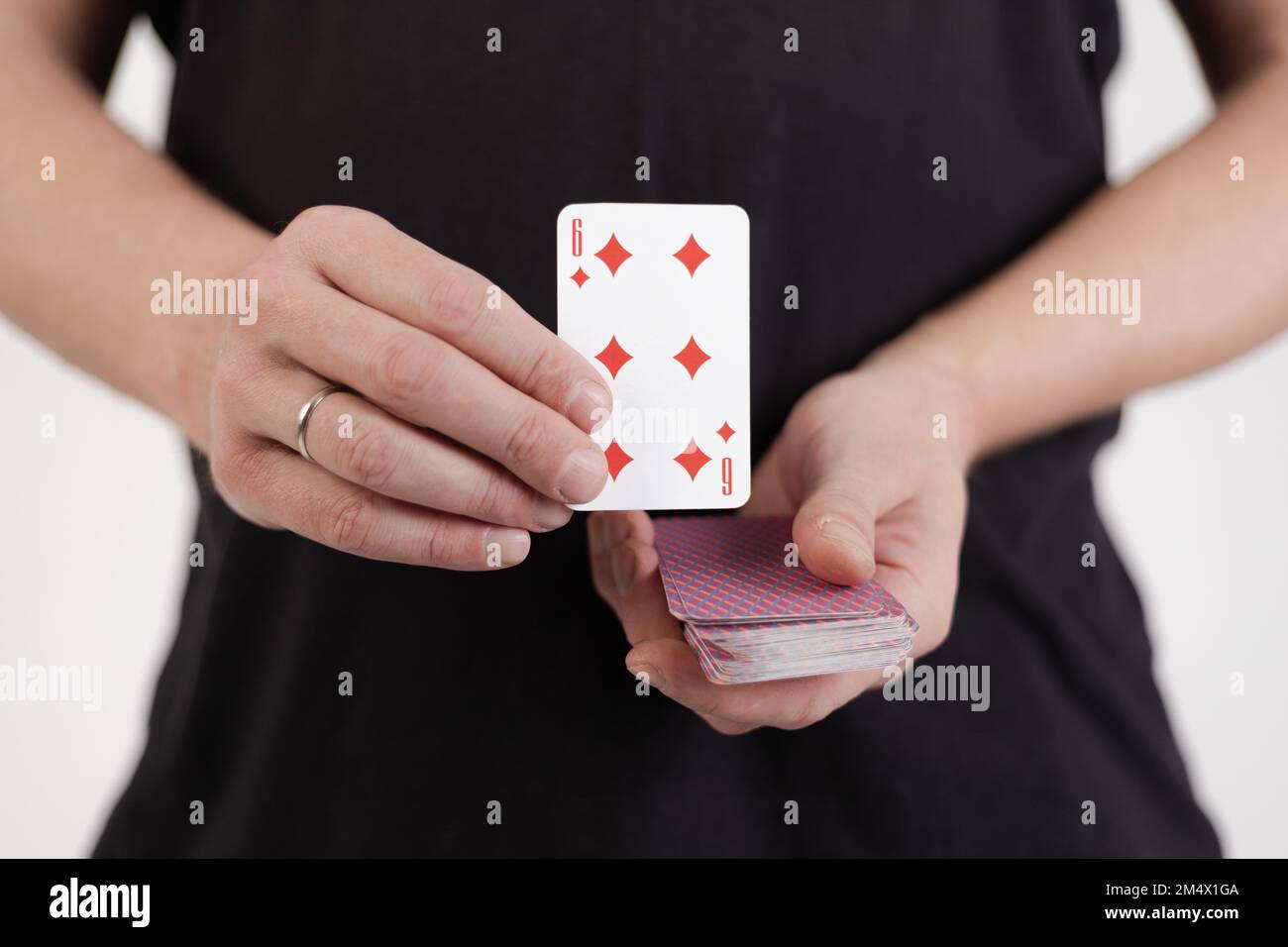 Male hands hold a deck of cards and show tricks Stock Photo - Alamy