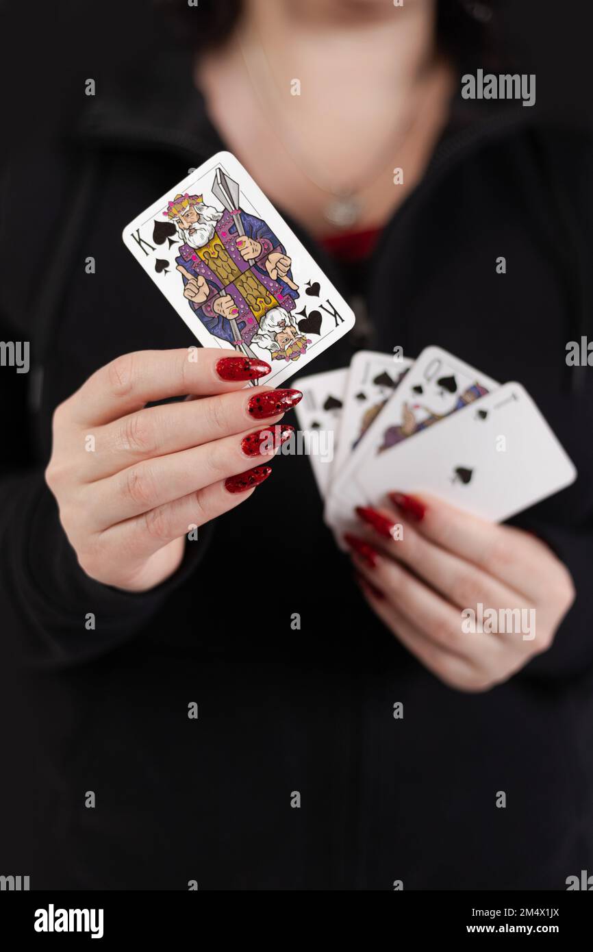 Girl holding deck cards hi-res stock photography and images - Alamy