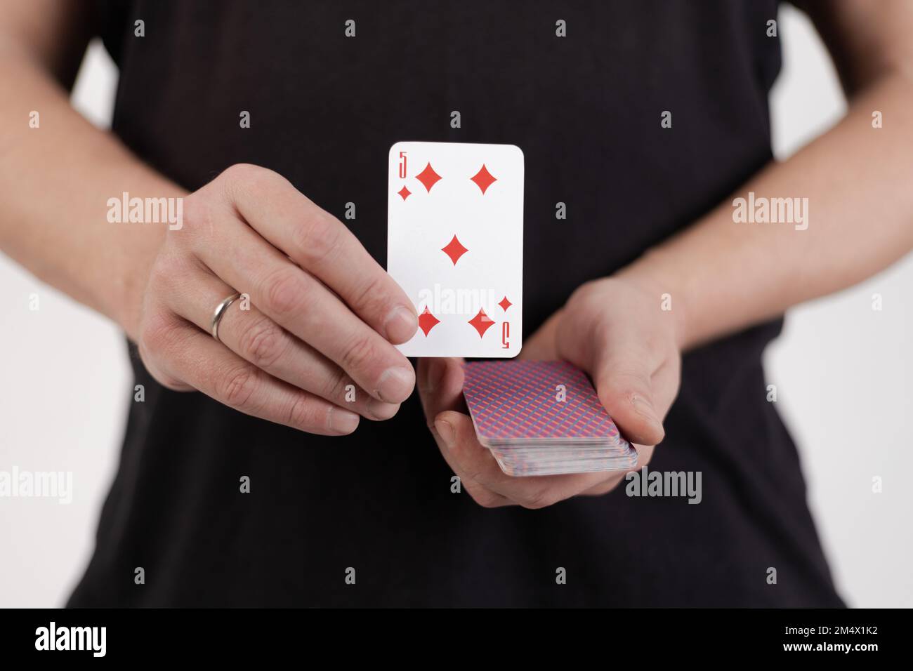 Male hands hold a deck of cards and show tricks Stock Photo - Alamy