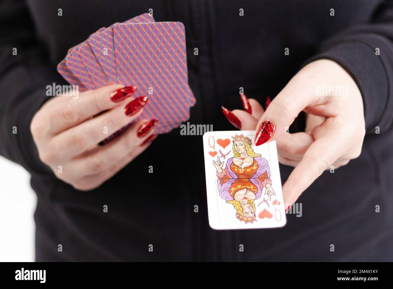 Girl holding deck cards hi-res stock photography and images - Alamy