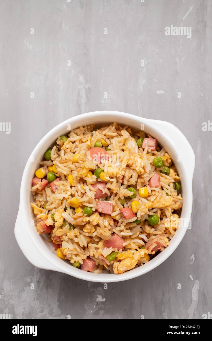 Rice with corn. peas, ham on white small bowl Stock Photo - Alamy