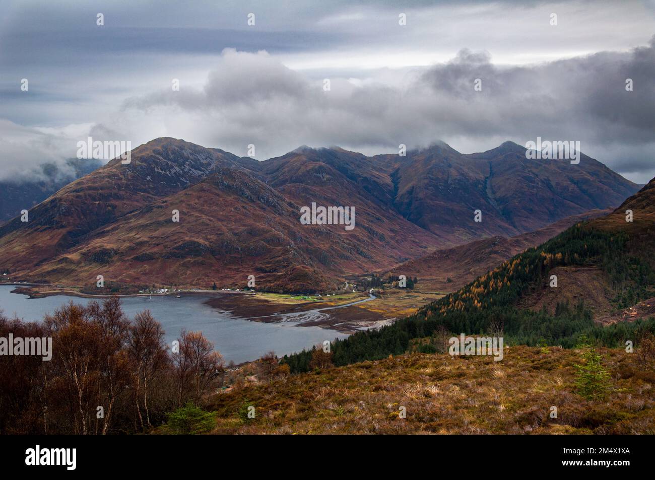 The 5 sisters of Kintail at the head of Loch Duich under a heavy sky ...