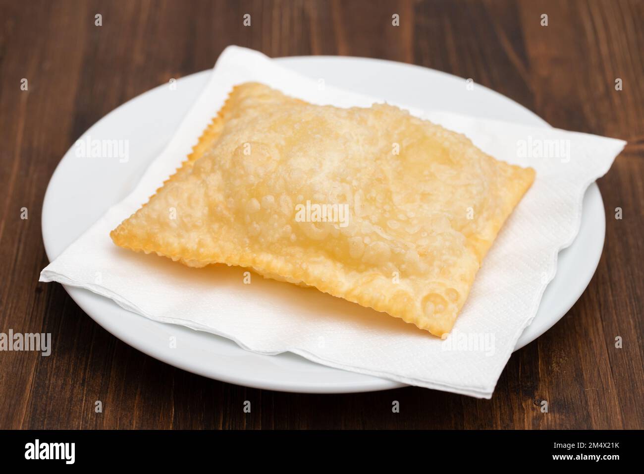 typical brazilian fried pastry on white small plate Stock Photo - Alamy