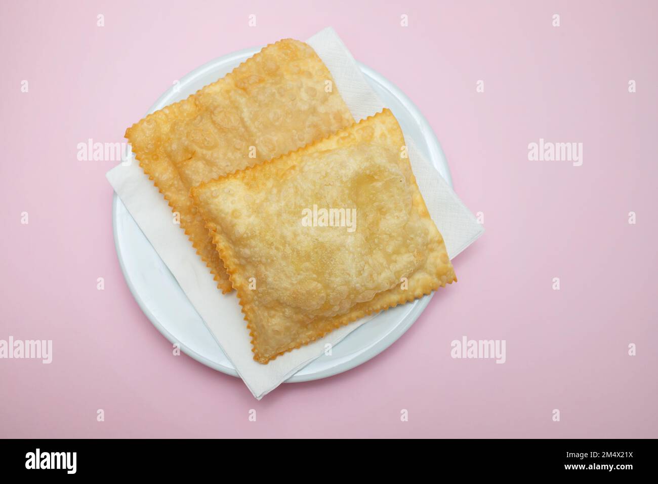 typical brazilian fried pastry on white small plate Stock Photo - Alamy