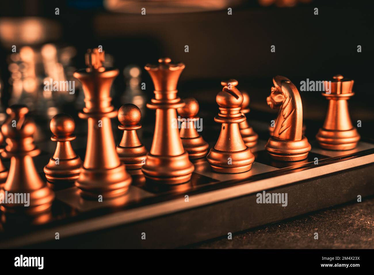 A close-up shot of golden chess pieces on a chessboard Stock Photo - Alamy