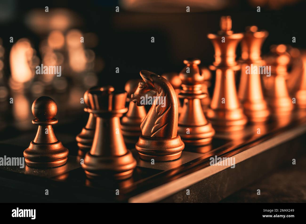 A close-up shot of golden chess pieces on a chessboard Stock Photo - Alamy