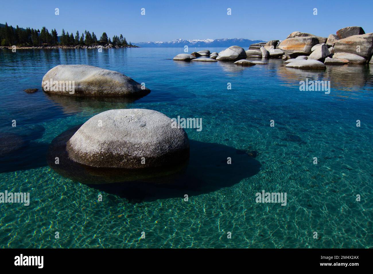 Lake Tahoe's clear blue water reflects the warm summer day, near Sand ...