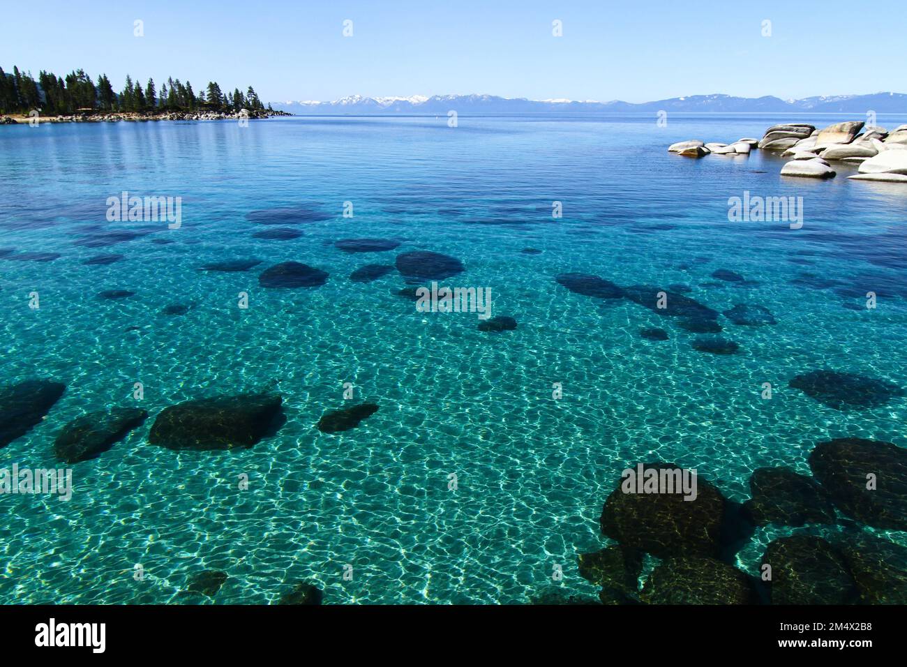 Lake Tahoe's clear blue water reflects the warm summer day, near Sand ...