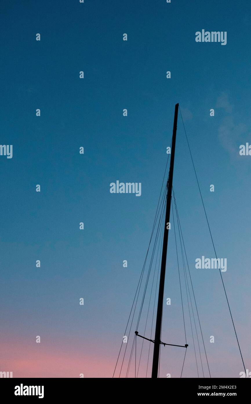 A beautiful shot of the masts of boat under the blue sunset sky Stock ...