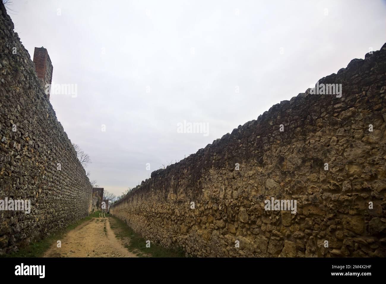 Dirt path bordered by fortifications in a park on a cloudy day Stock ...