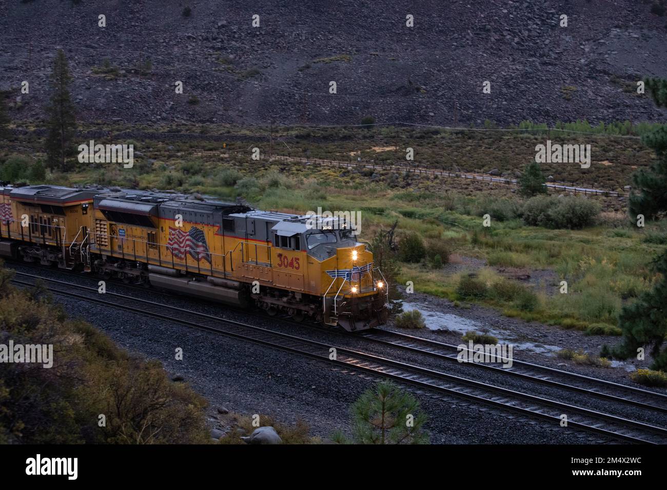 A Union Pacific engine travels over the Sierra Nevada Mountains between ...
