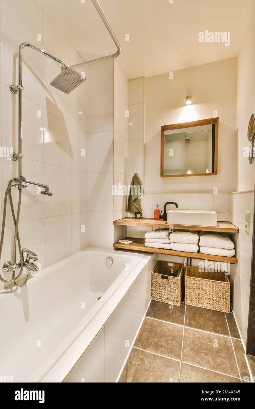 a bathroom with a sink, mirror and bathtub on the wall in this photo is ...