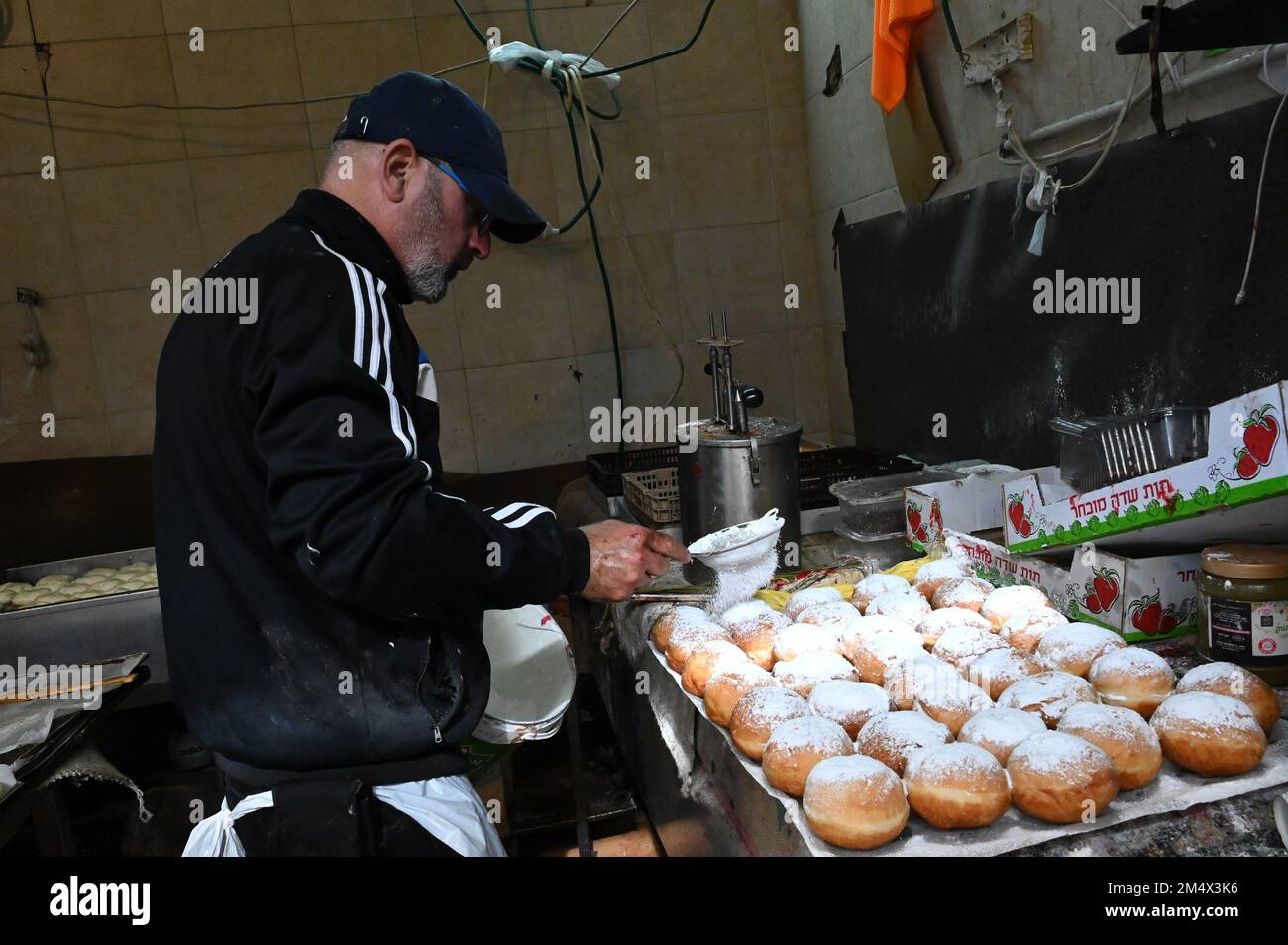 Jerusalem, Israel. 23rd Dec, 2022. A baker puts powered sugar on the ...