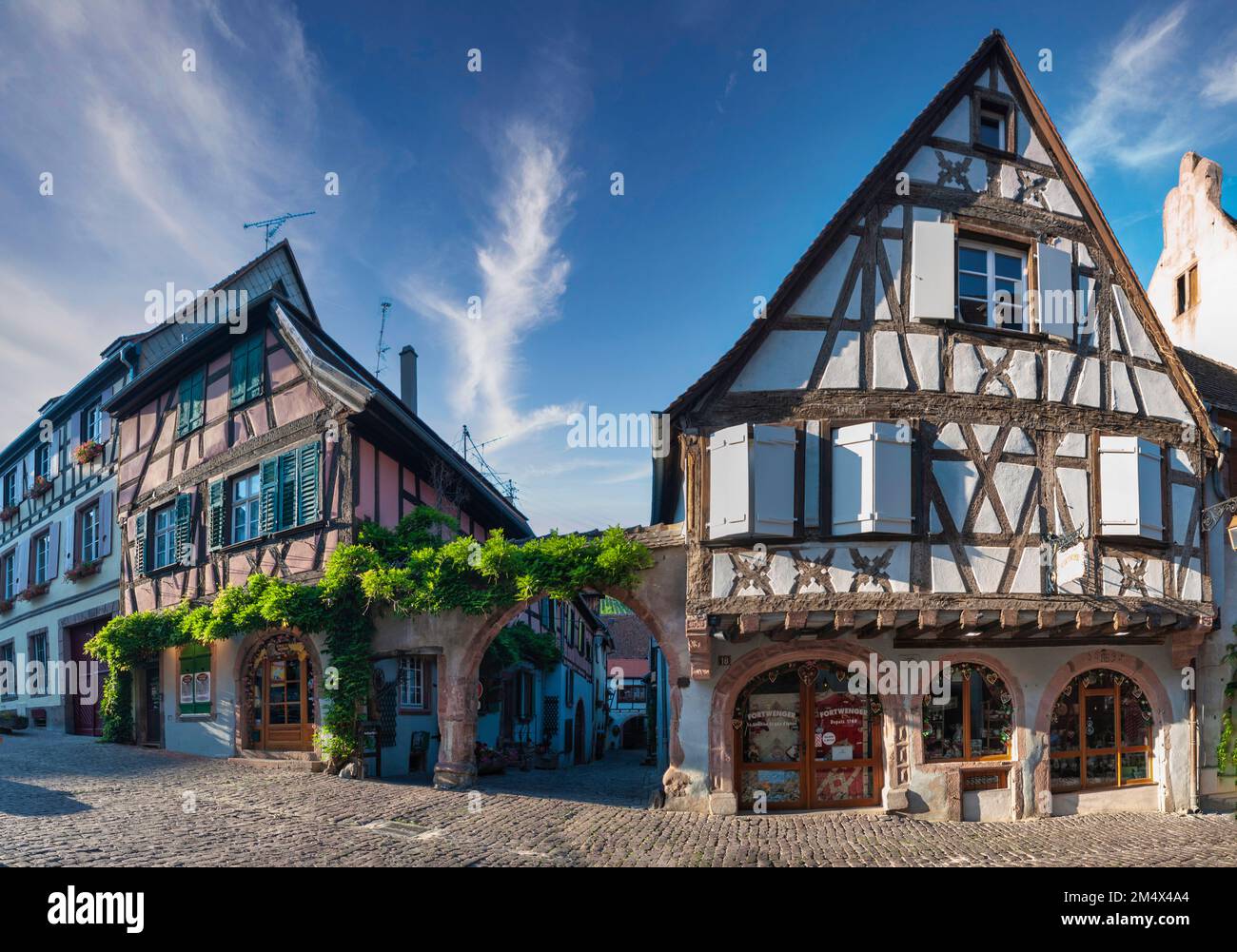 Traditional colorful half-timbered houses in Riquewihr village , Alsace ...