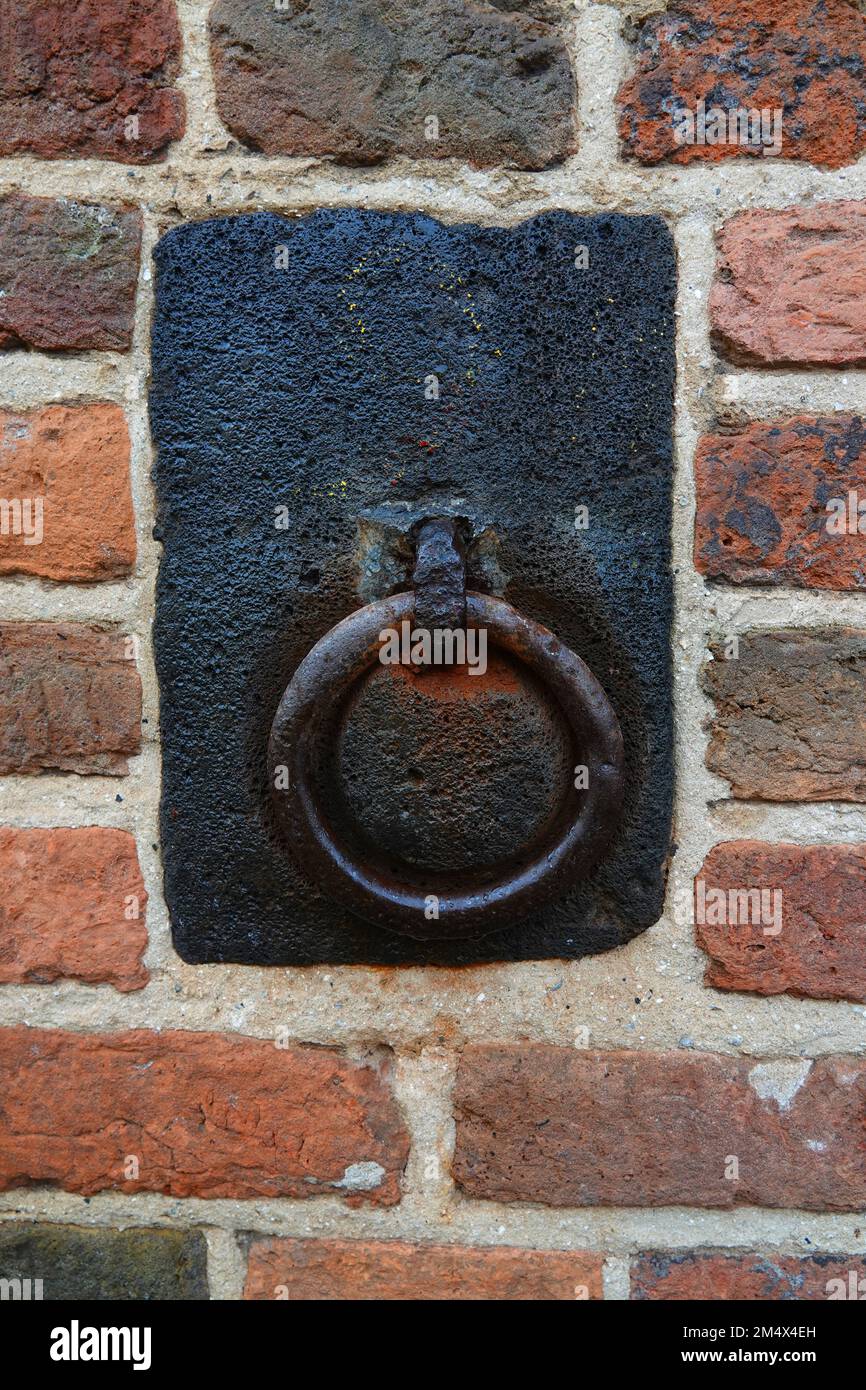 An iron horse tie ring built into the wall from a bygone era. Seen in ...