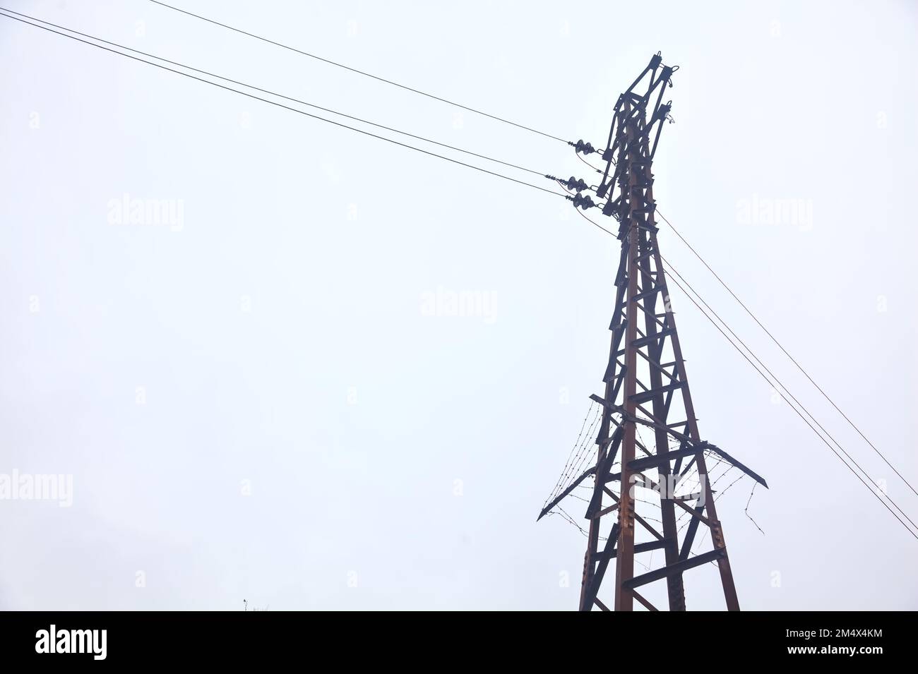 Over head cables held by pylons with a cloudy sky as background Stock ...