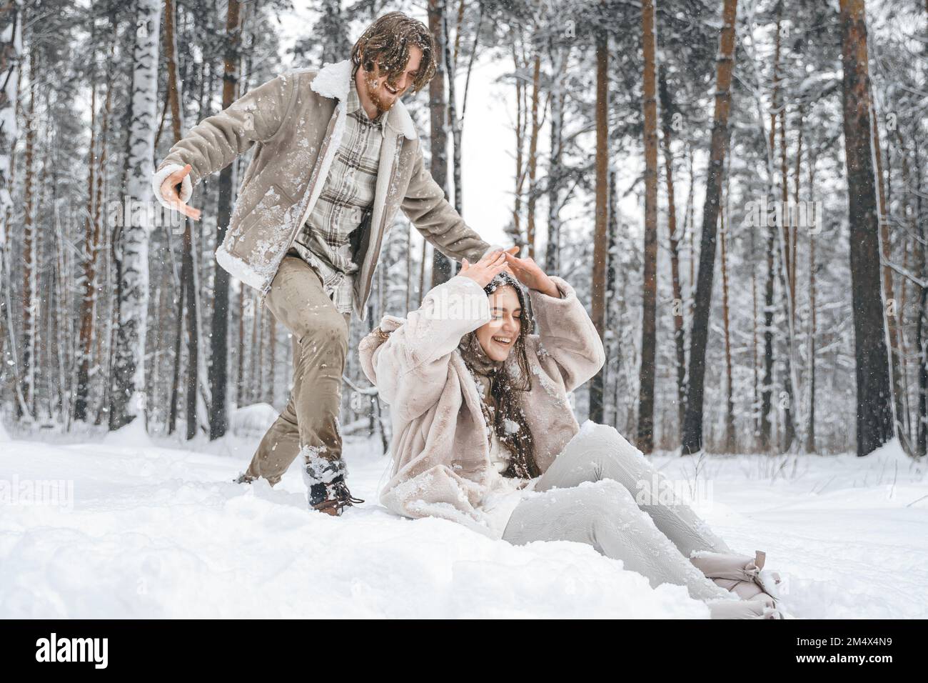 Romantic snow love story.Young couple guy girl lying,playing in snowy ...