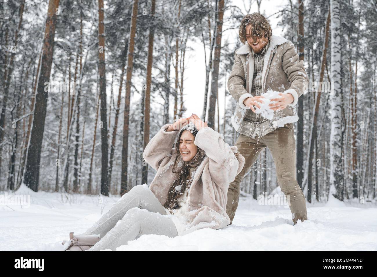 Romantic snow love story.Young couple guy girl lying,playing in snowy ...