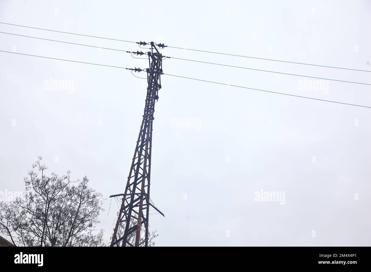 Over head cables held by pylons with a cloudy sky as background Stock ...