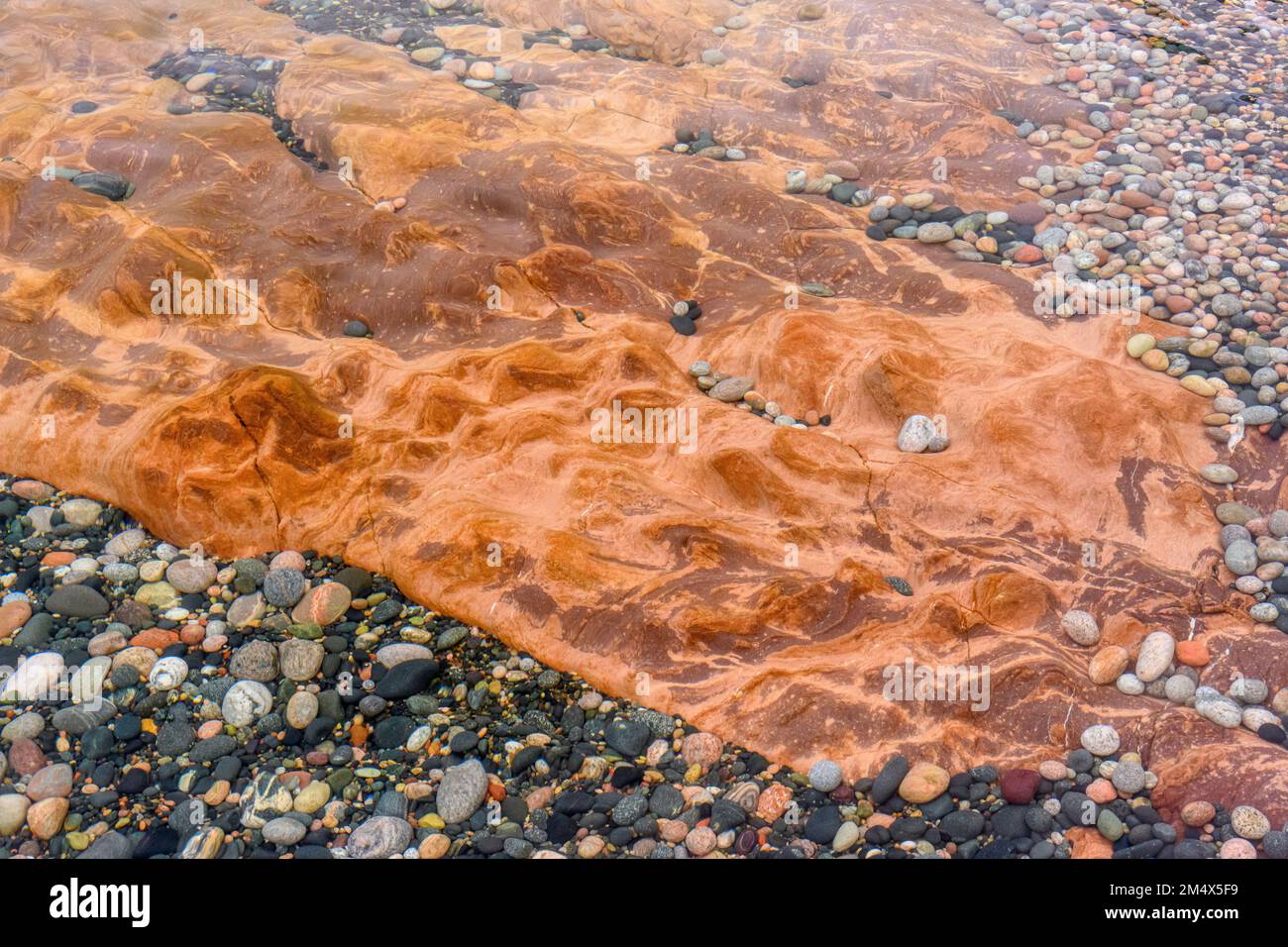 Wave-polished cobblestones and rocks at Sawpit Bay, Sawpit Bay, Ontario ...