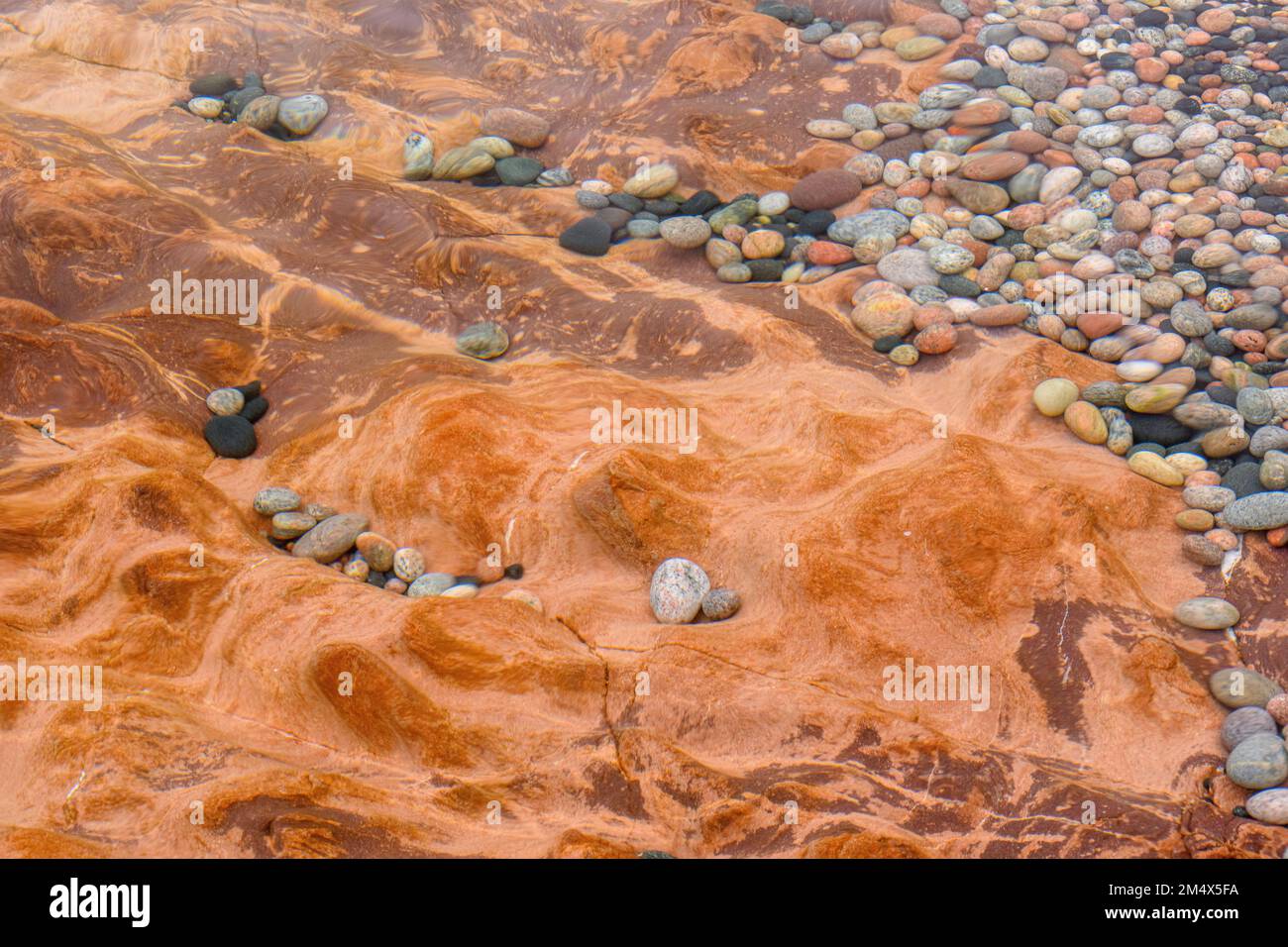 Wave-polished cobblestones and rocks at Sawpit Bay, Sawpit Bay, Ontario ...