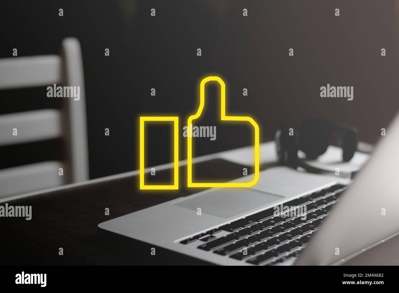 Yellow like icon on minimal workplace background. Social media approval ...