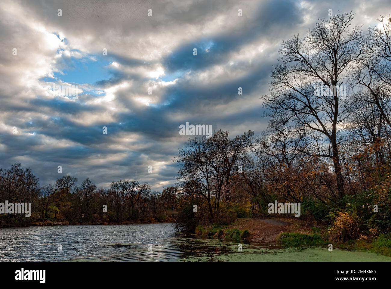 The DuPage River flows through Hammel Woods Forest Preserve in Will County, Illinois under a sky ...