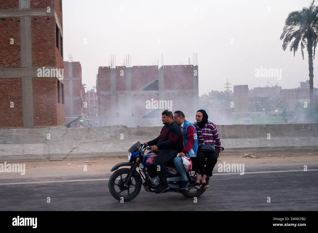 Egypt. 13th Nov, 2022. A motorcycle with 3 people is driving on a road ...
